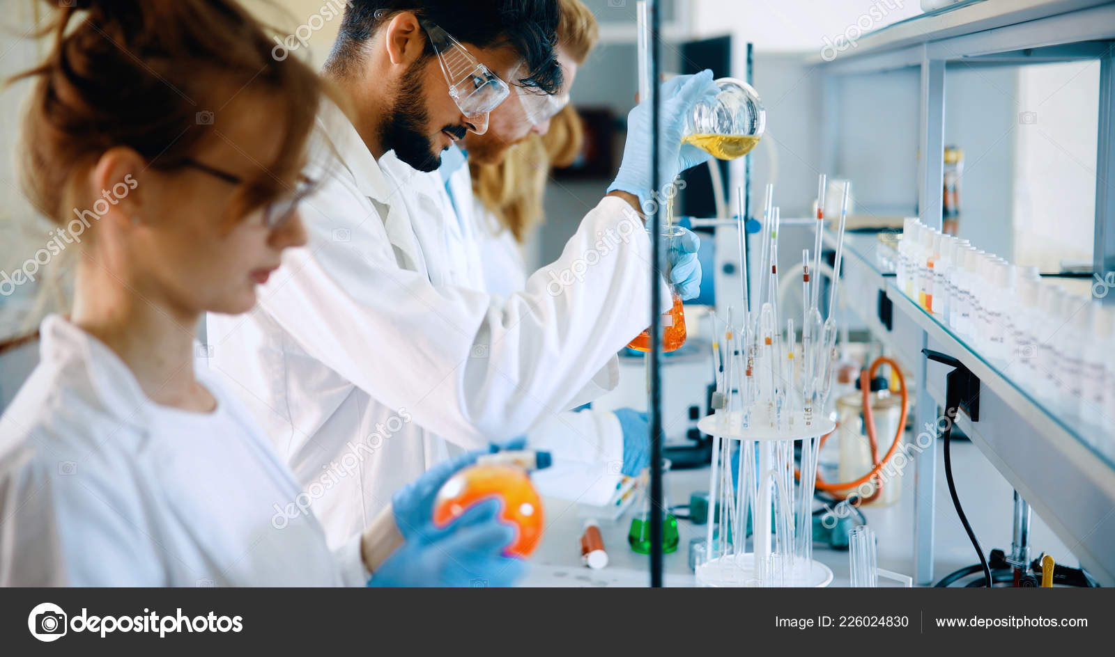 Young Students Chemistry Working Together Laboratory Stock Photo by ...