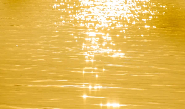 Abstract Solar reflective surface gold background. Bokeh effect. Smooth ...