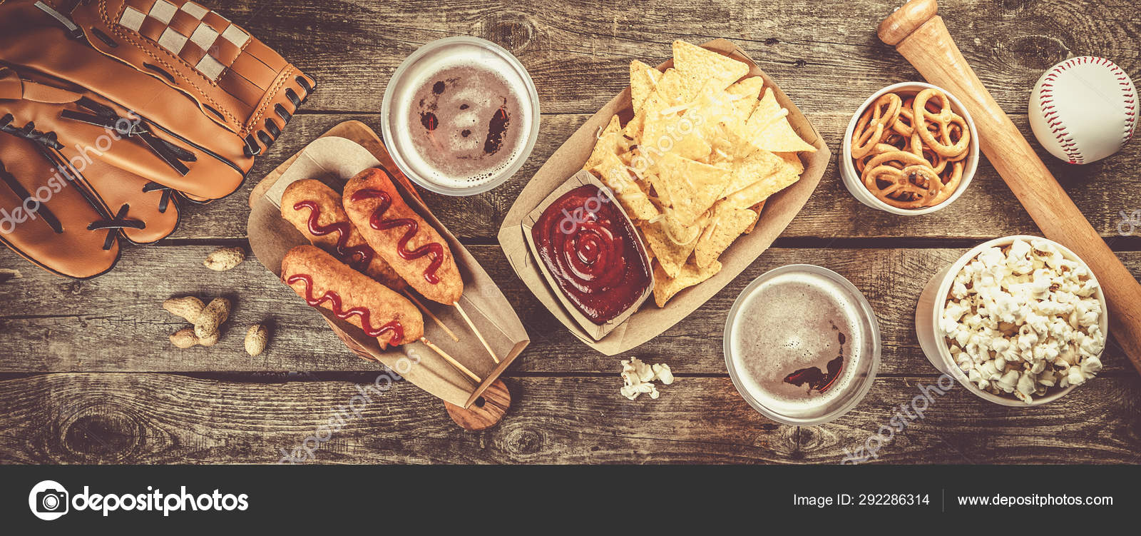 Selection of stadium game foods - nachos, pop corn, pretzels, corn dogs ...