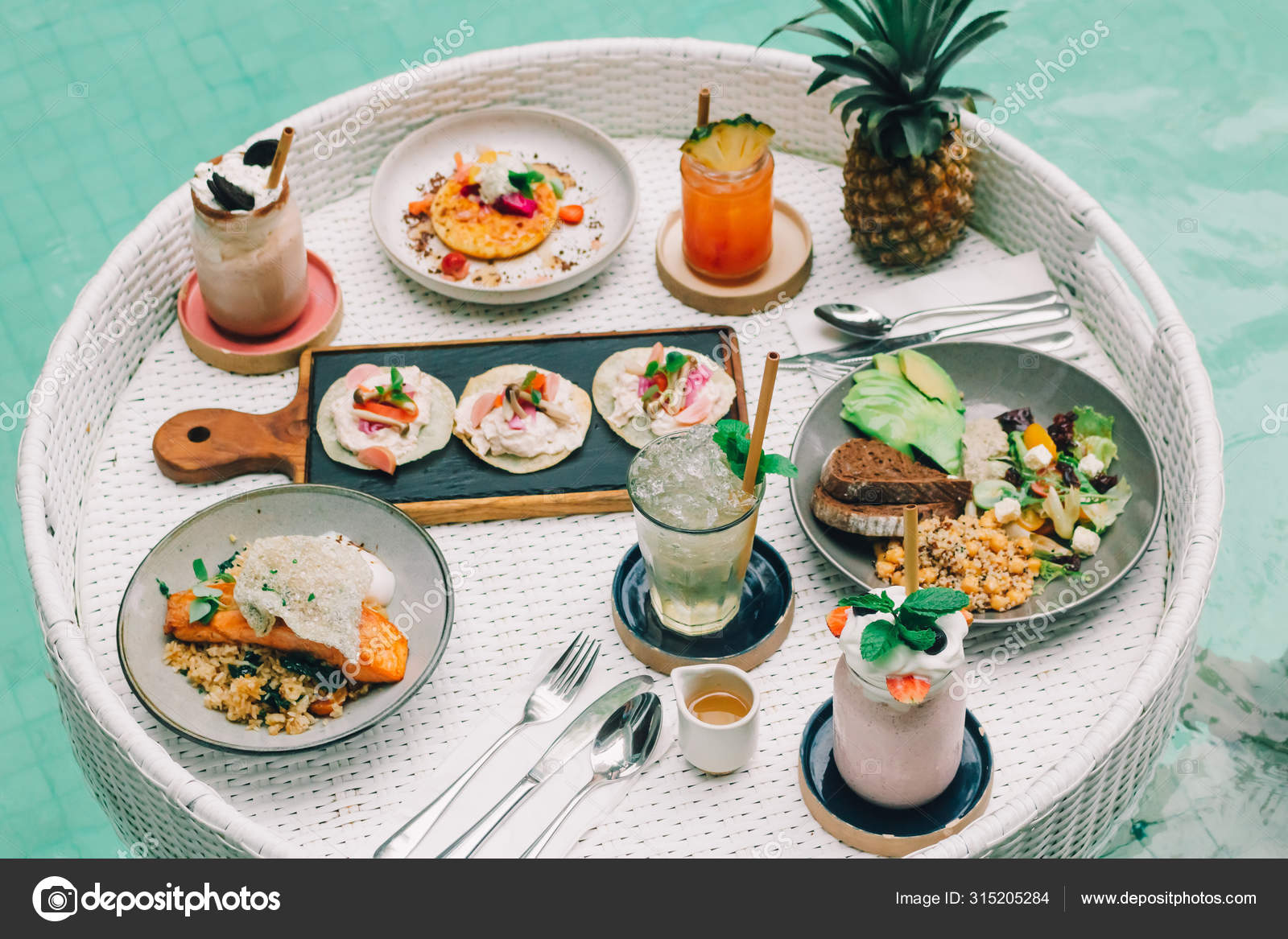 Breakfast on floating table in the pool. Healthy food with smoot ...
