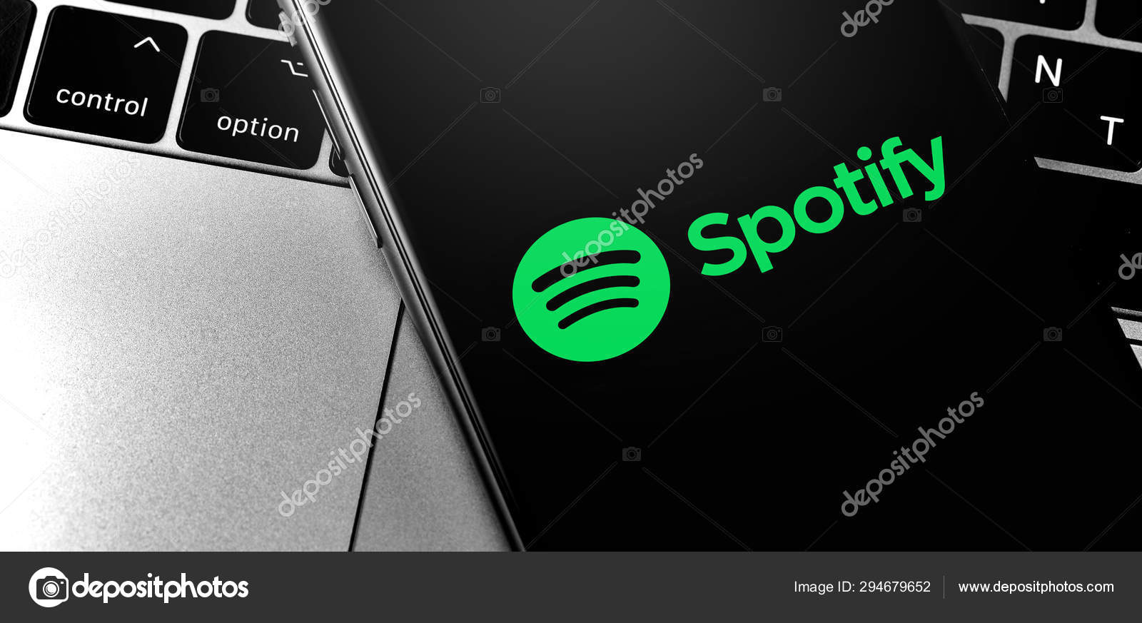 Closeup Macbook and iPhone with Spotify logo on the screen — Stock ...