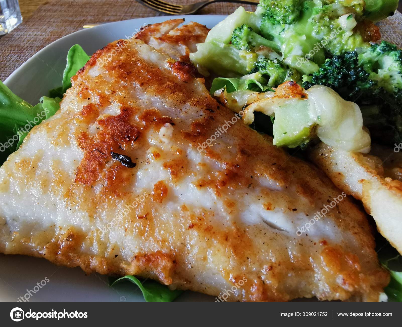 Fried fish. Breaded walleye fillet. Garnish with broccoli and green ...
