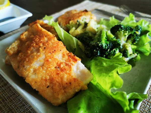Fried fish. Breaded walleye fillet. Garnish with broccoli and green ...