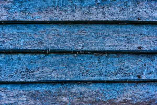 Blue faded painted wooden texture, background and wallpaper. The old blue wood texture with ...