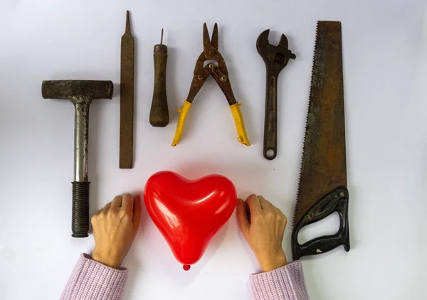 Red heart and hand tools. Love affair or breakup and divorce concept ...