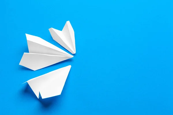 white paper airplane on a navy paper background - Stock Image - Everypixel
