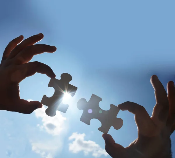 Hands Puzzle Pieces Sky Background Stock Photo by ©borjomi88 300759692