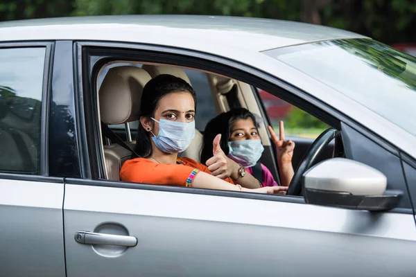 Indian Mother Daughter wearing Face Mask or medical mask while driving ...