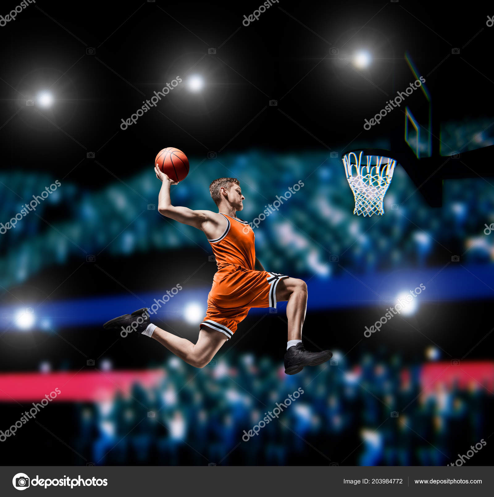 Basketball player making slam dunk on basketball arena Stock Photo by ...