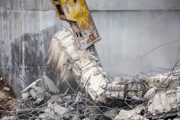 Professional demolition of reinforced concrete structures using - Stock ...