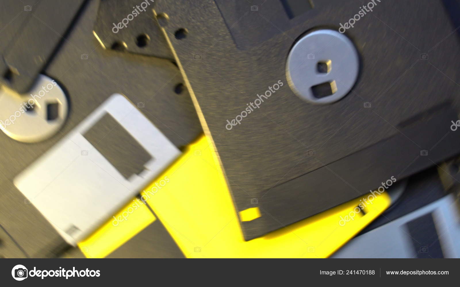 Pile of old style data transfer floppy discs, rotating spinning ...