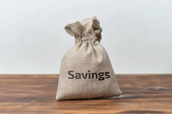 Money savings concept in a cloth bag. - Stock Image - Everypixel