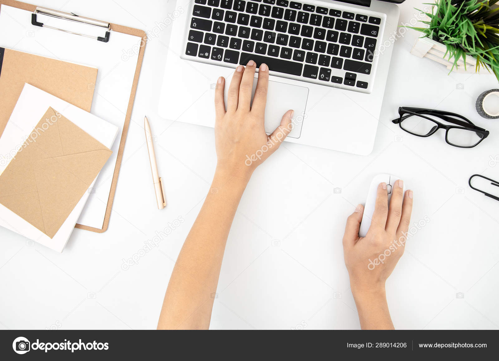 Top view white desk with laptop computer. Women typing text with hands ...