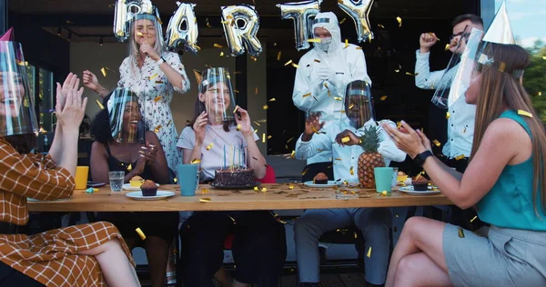 Birthday party during COVID-19. Young happy multiethnic friends dancing ...