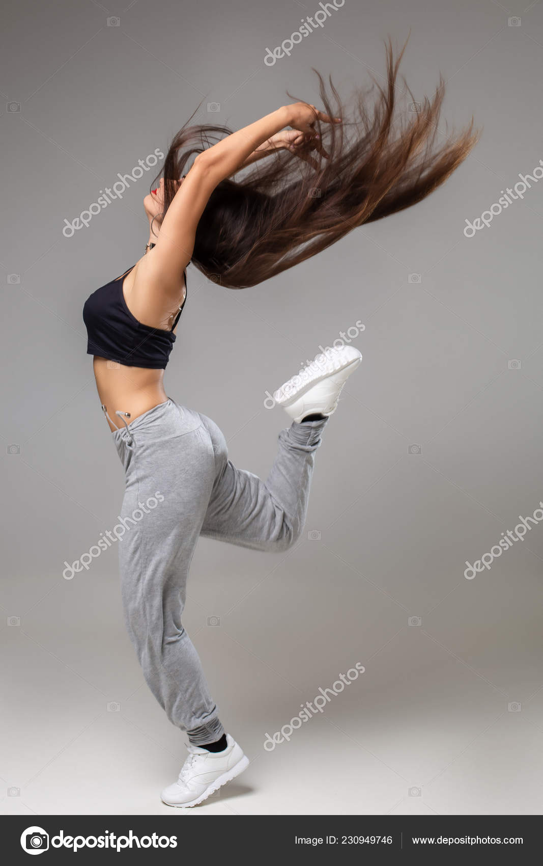 Modern dancer poses in front of the gray studio background — Stock ...
