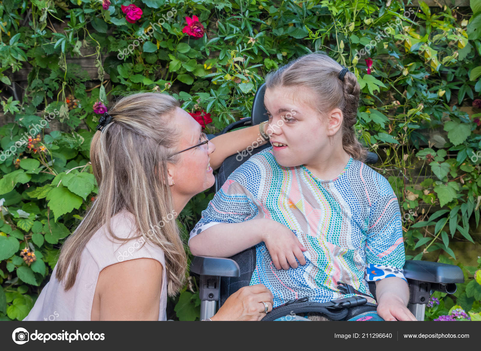 A disabled child in a wheelchair being cared for by a voluntary care ...