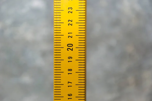 yellow tape measure on grange cement wall background. measuring tape ...