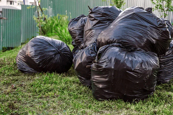 Heap garbage plastic bags many in the garden, pollution from tra ...