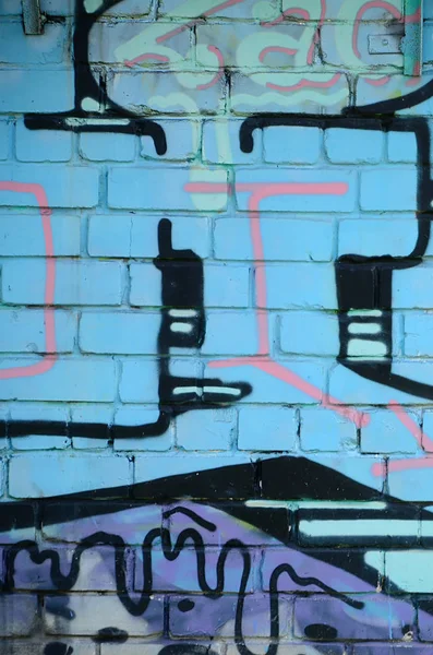 Fragment of graffiti drawings. The old wall decorated with paint stains ...