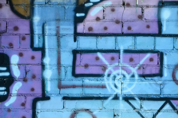 Fragment of graffiti drawings. The old wall decorated with paint stains ...