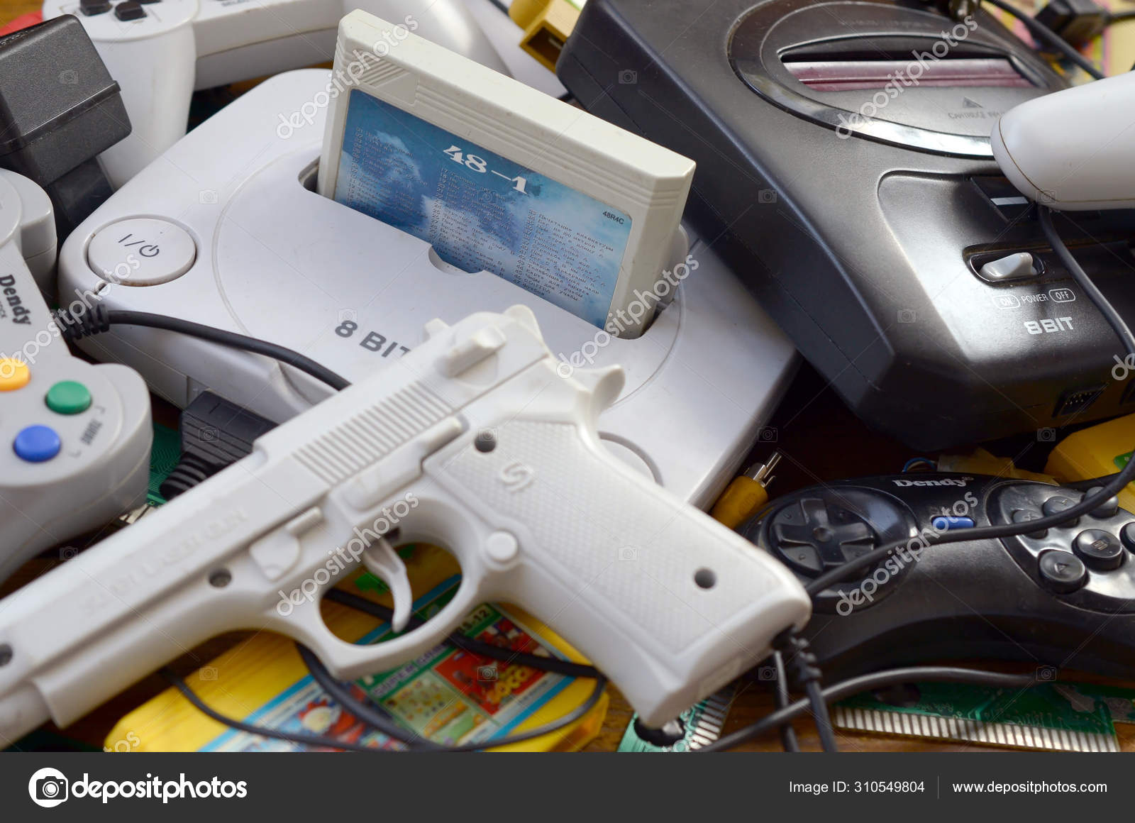 Pile of old 8-bit video game consoles and many gaming accessories like ...