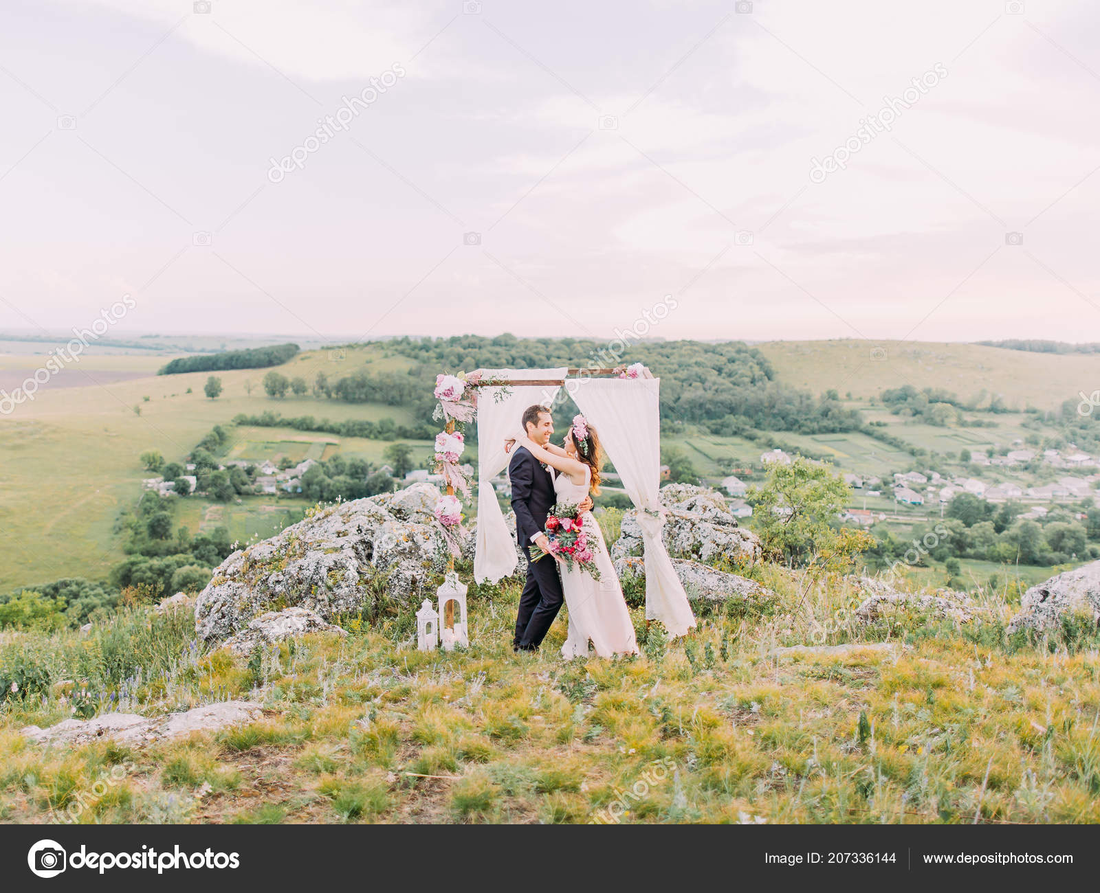 Horizontal photo of the hugging newlywed couple near the lovely ...