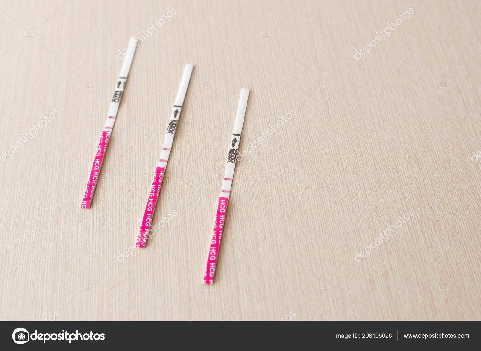 Three positive pregnancy test result with two strips on the table ...