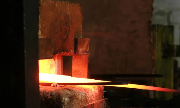 Making the sword out of metal at the forge. Blacksmiths hand pulls out ...