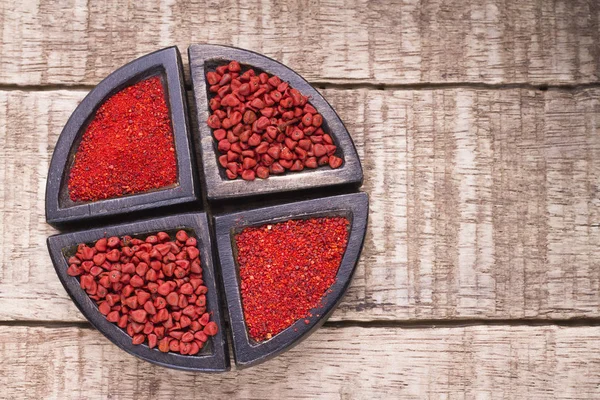 Achiote grains and powder in wooden bowl Stock Photo by ©CUNDO 164888426