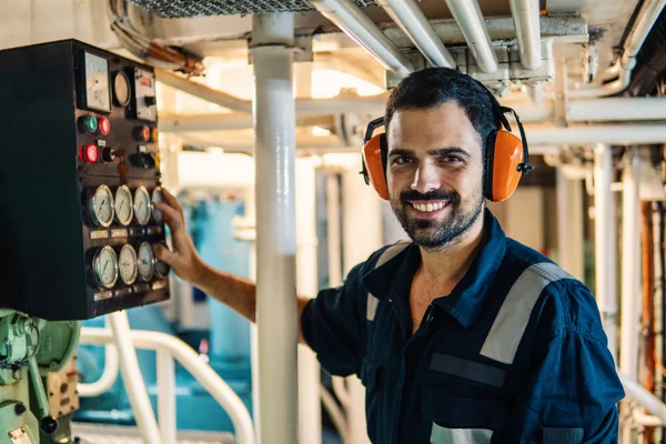 Marine engineer officer working in engine room - Stock Image - Everypixel