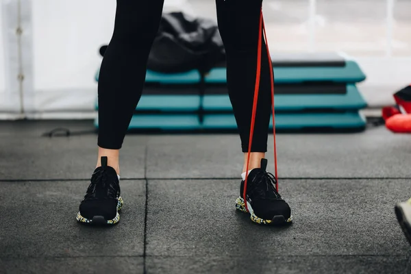 Exercising with yoga belt. Close-up of woman's leg during exercising ...