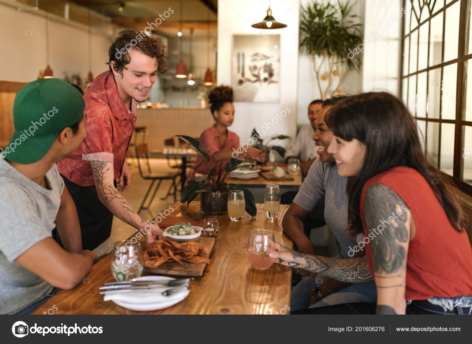 Friendly Waiter Serving Delicious Freshly Made Tapas Group Laughing ...