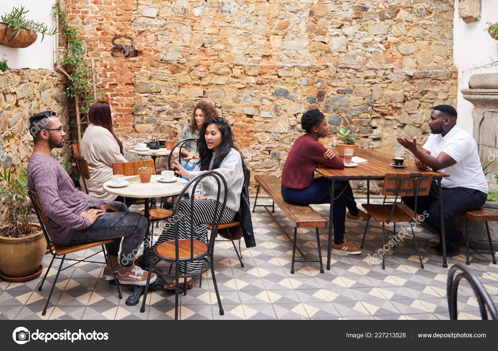 Group Of People Talking At Table