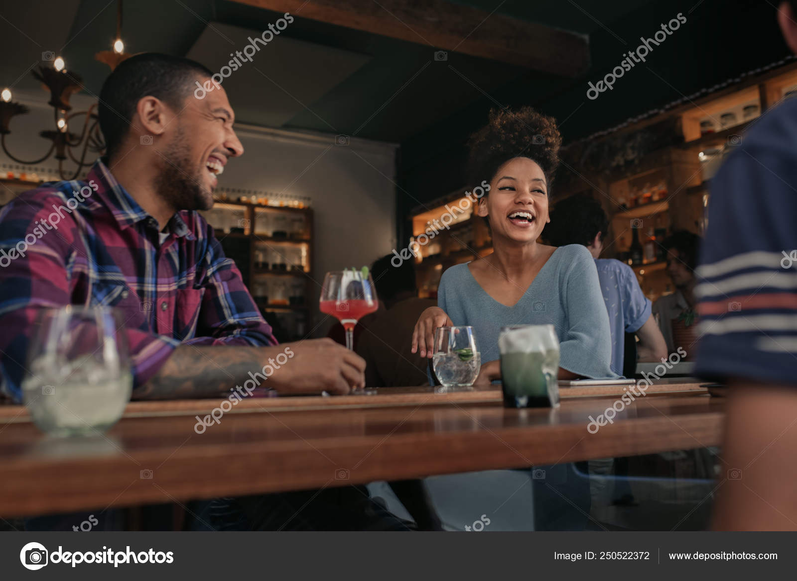 Laughing Group Friends Having Drinks Together While Sitting Table Bar ...