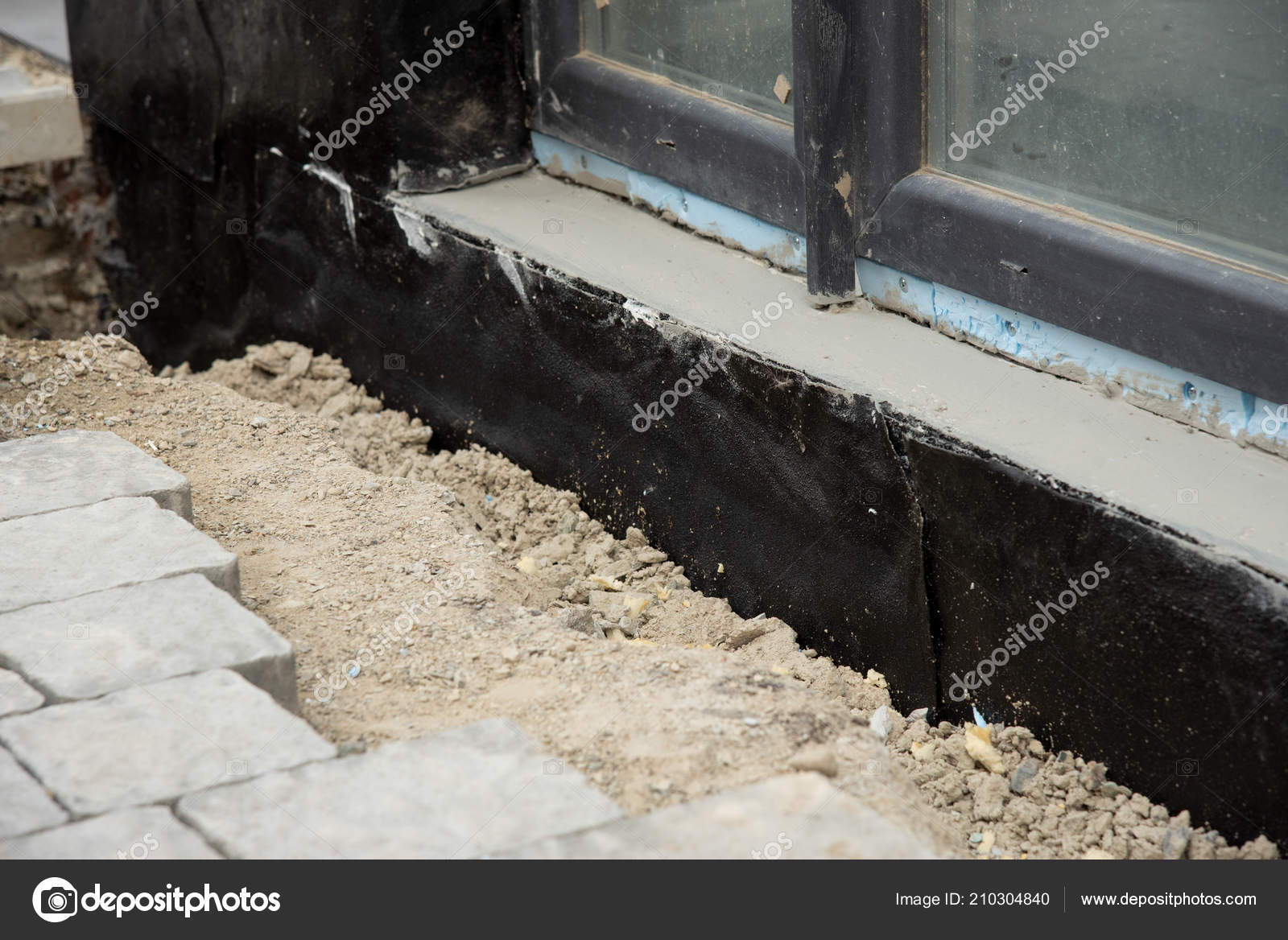 Waterproofing house foundation with spray on tar and roll waterproofing ...