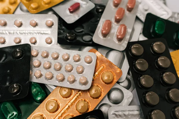 Stock photo of a bunch of tablets in colored blister packaging. There ...