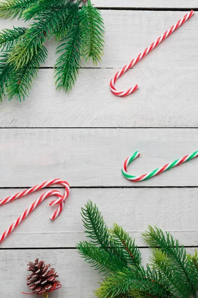Candy canes flat lay on white wooden background. Christmas and New Year ...