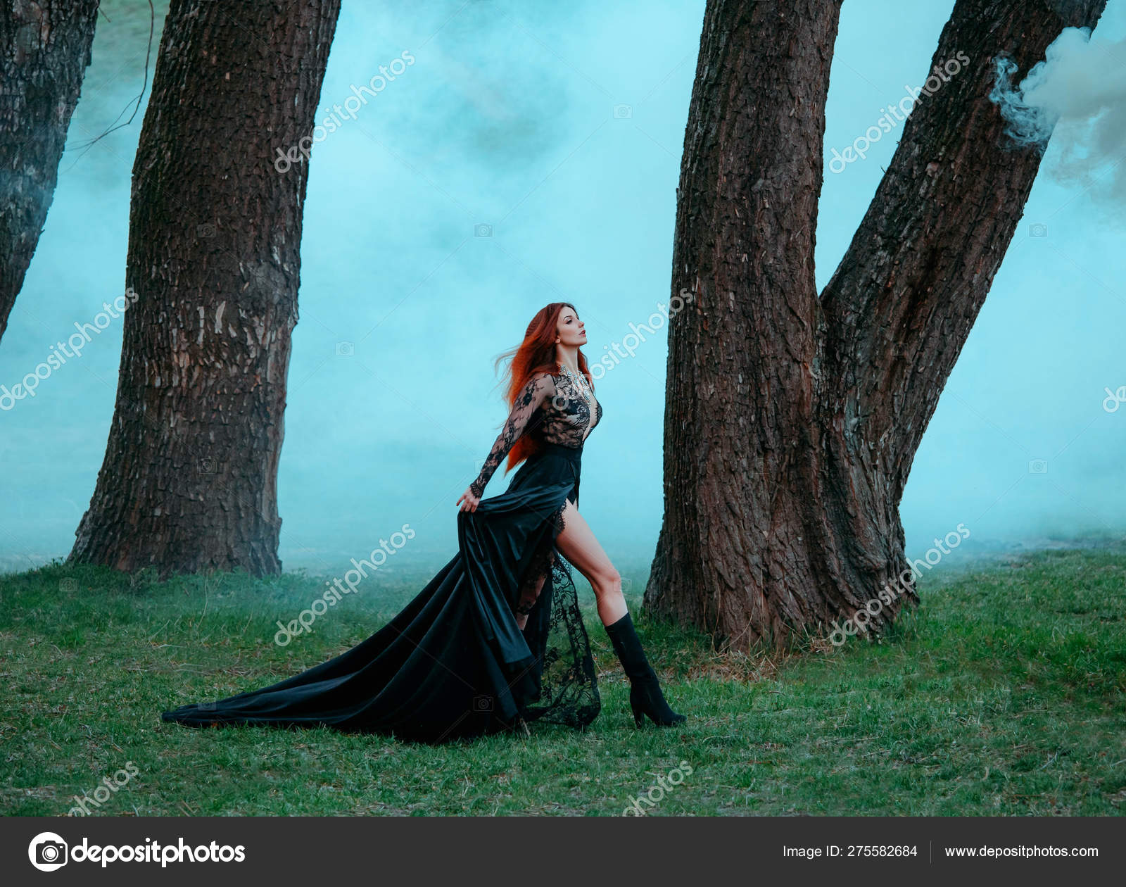 Severe dark queen with bright red flying hair in chic royal lace dress ...