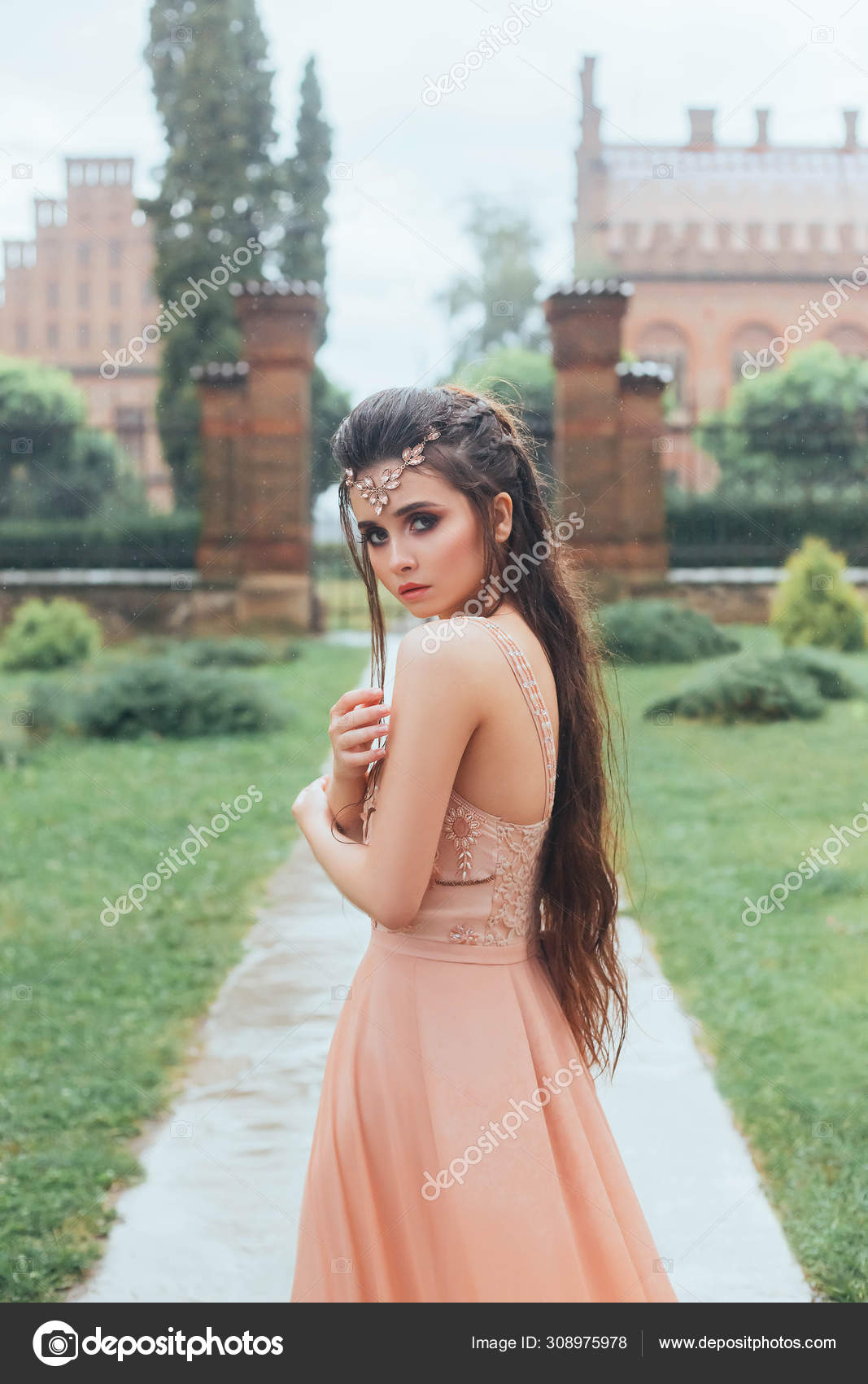 Portrait of a sad, lonely, scared princess who stands frozen and wet in ...