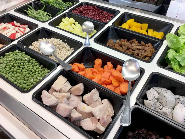 Fresh salad bar with various fresh assortment of ingredients, fruits ...