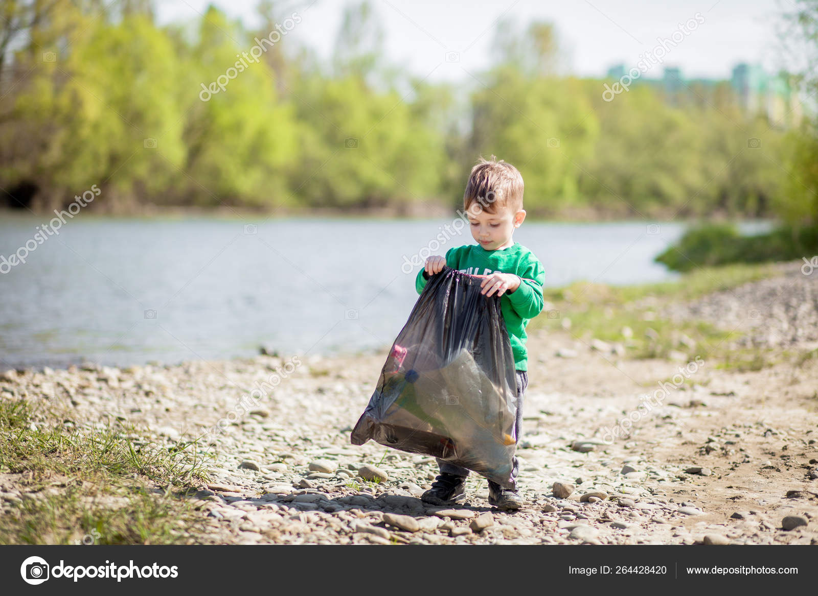Save environment concept, a little boy collecting garbage and pl Stock ...