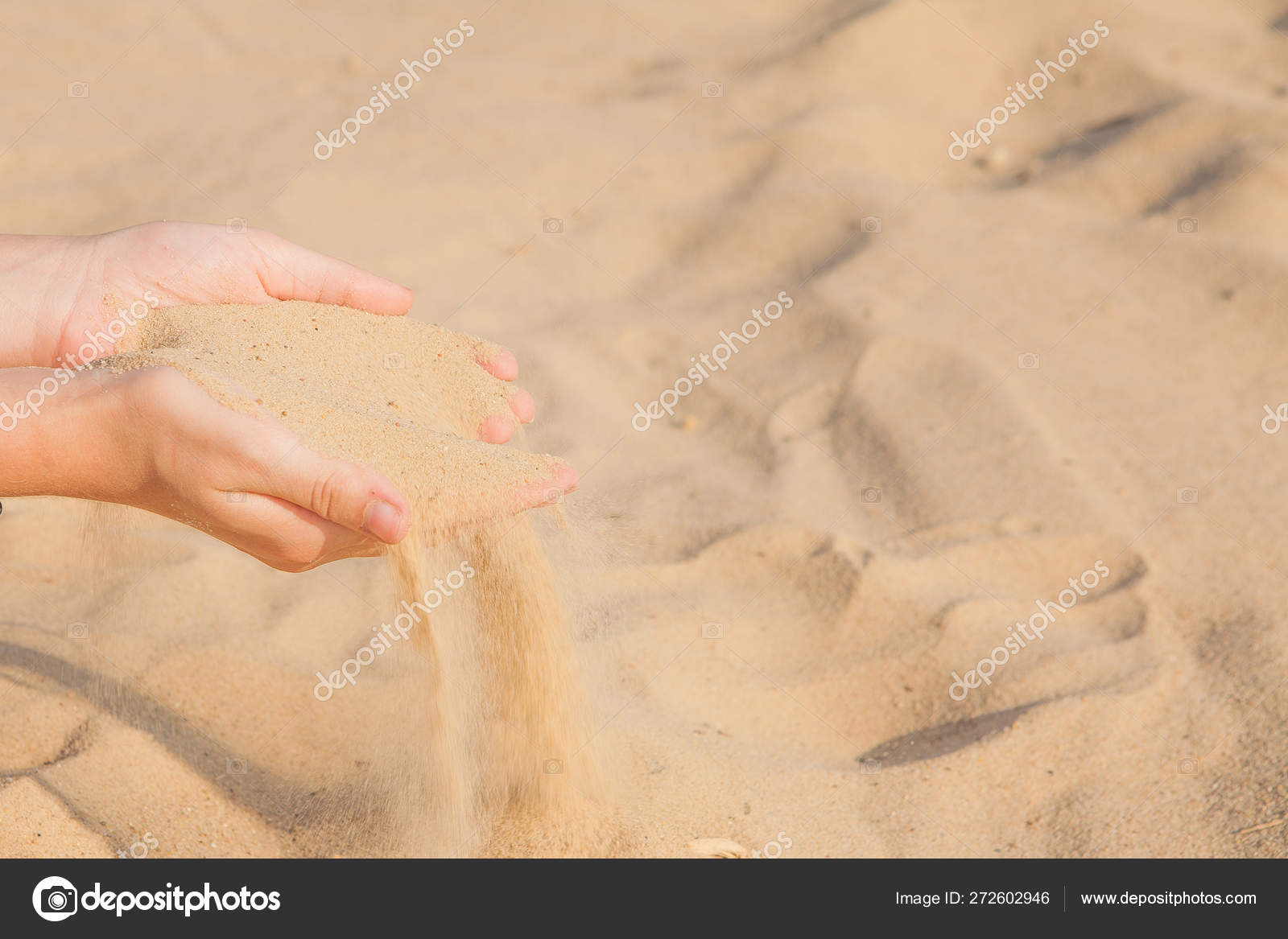 Sand flowing through the woman's hands on the beach Stock Photo by ...