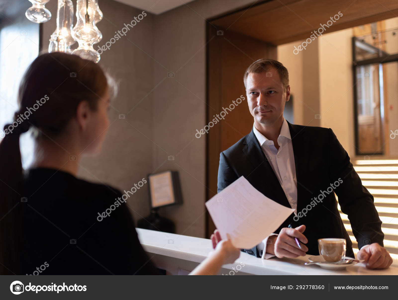 Female receptionist passing paper form to businessman — Stock Photo ...