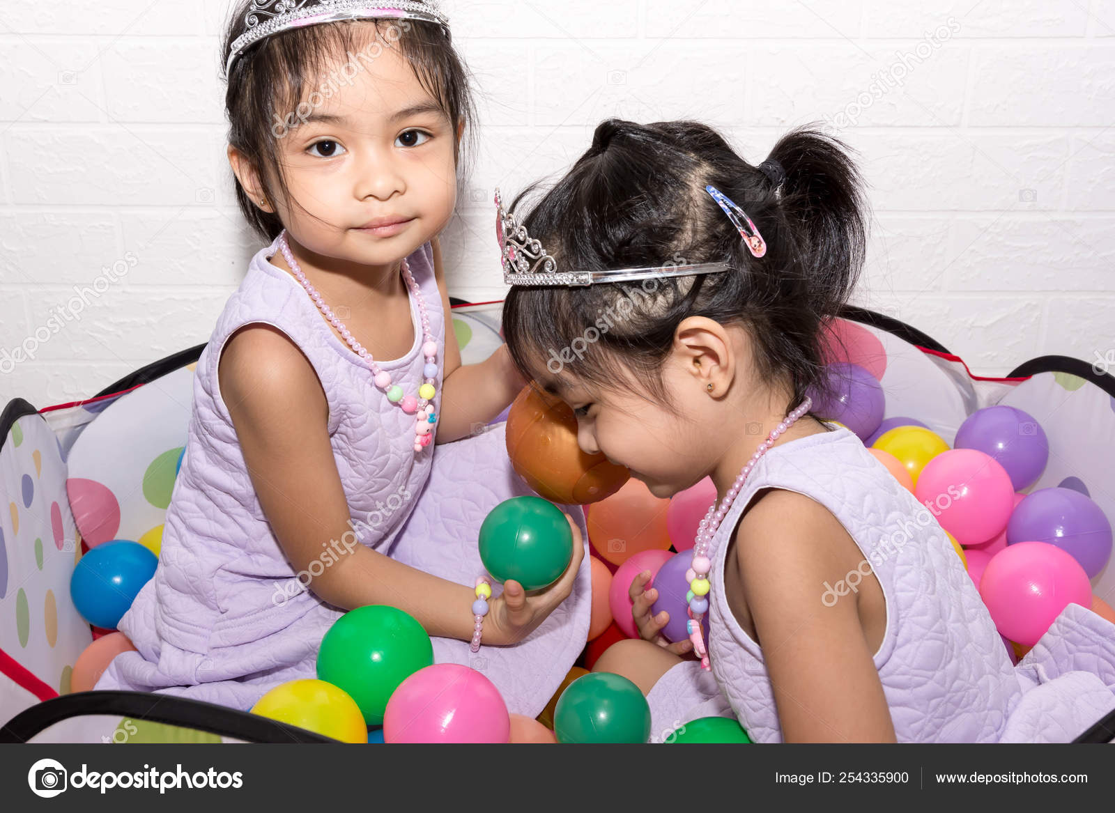 Female asian identical twins sitting on chair with white backgro Stock ...