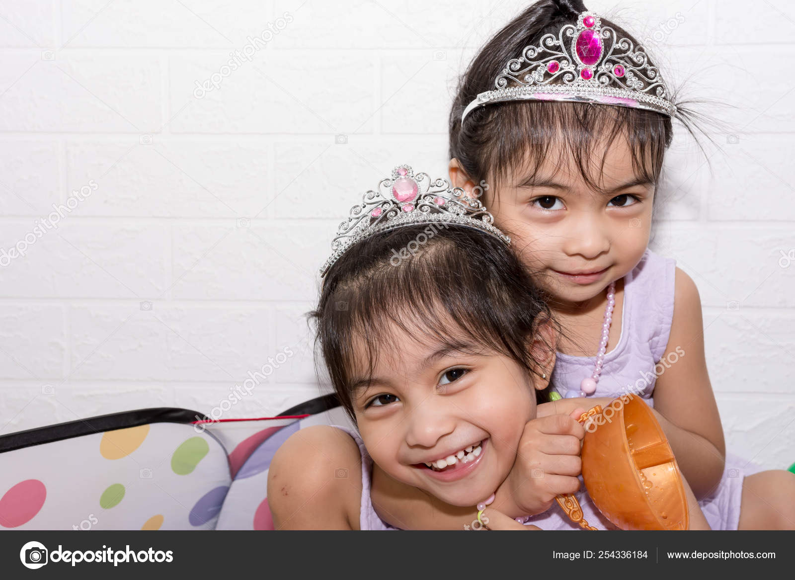 Female asian identical twins sitting on chair with white backgro Stock ...