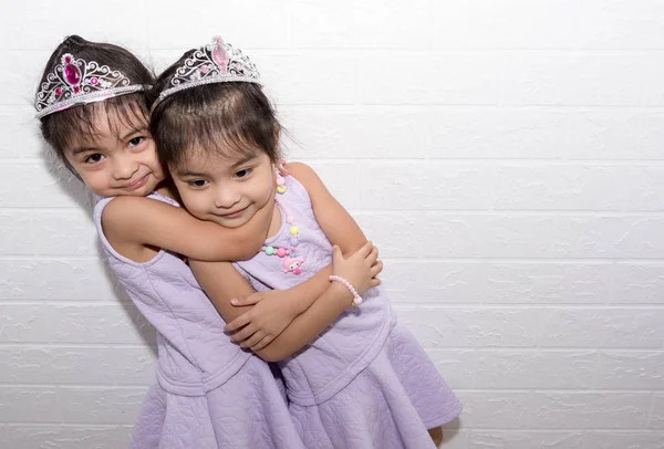 Female asian identical twins sitting on chair with white backgro Stock ...