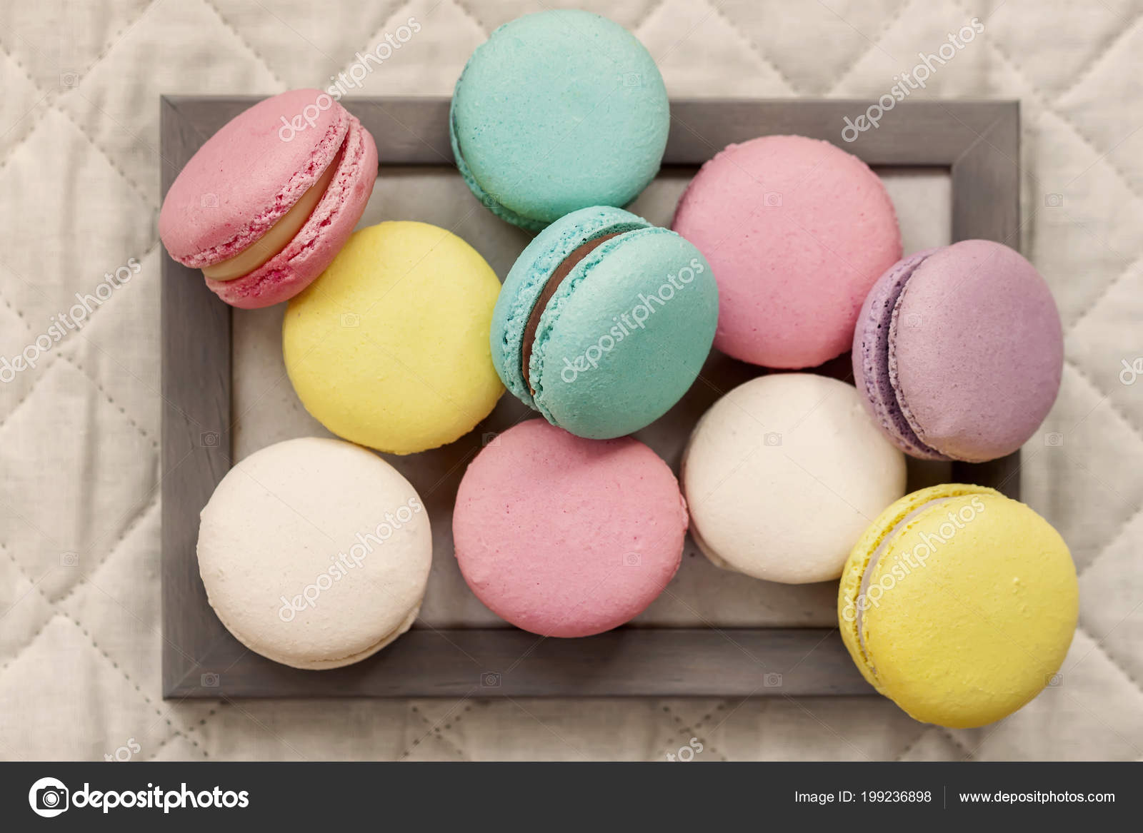 Fresh natural colorful macarons of different tastes in wooden frame on ...