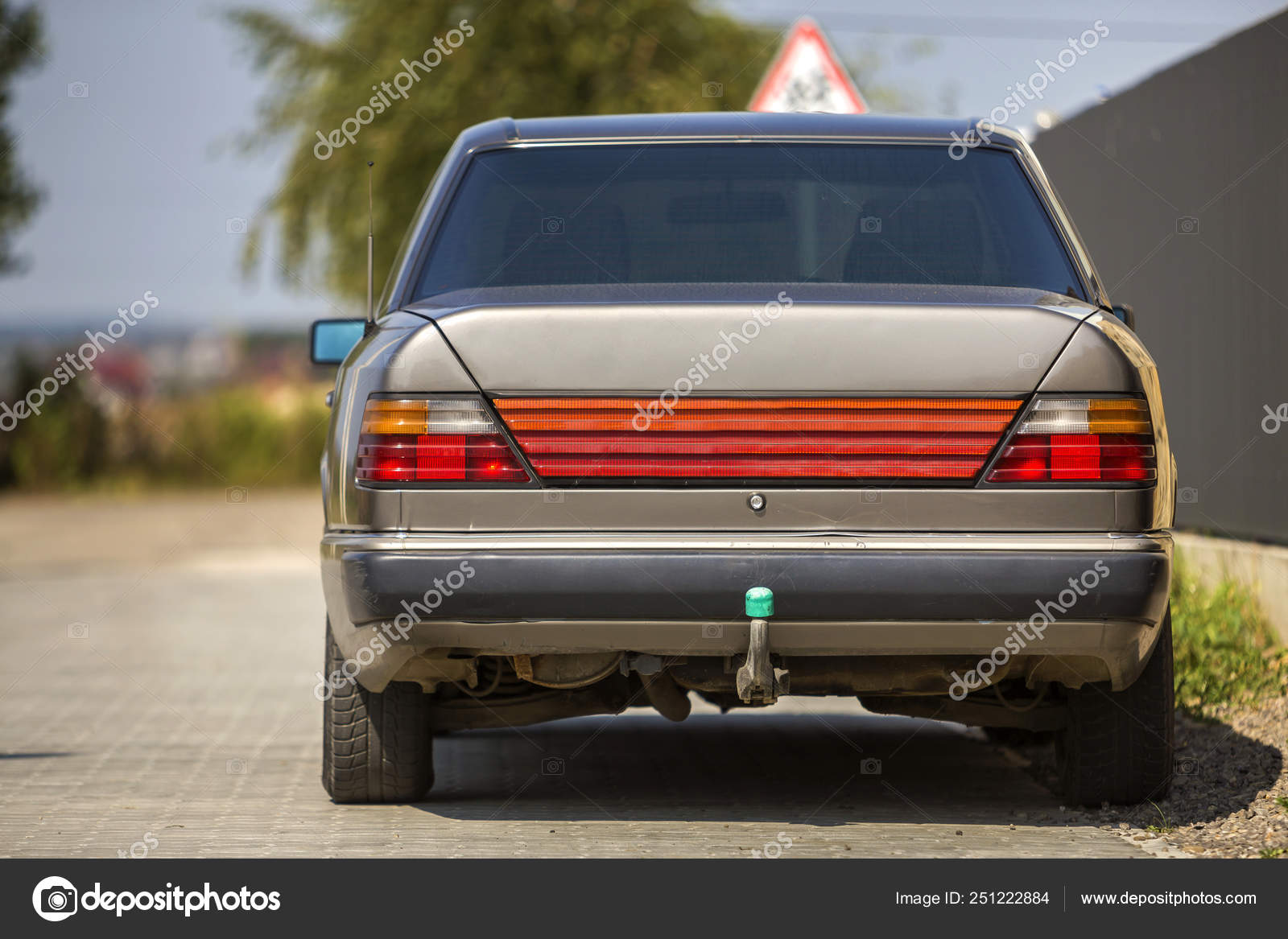 Back view of silver car parked on paved street in quiet area on Stock ...