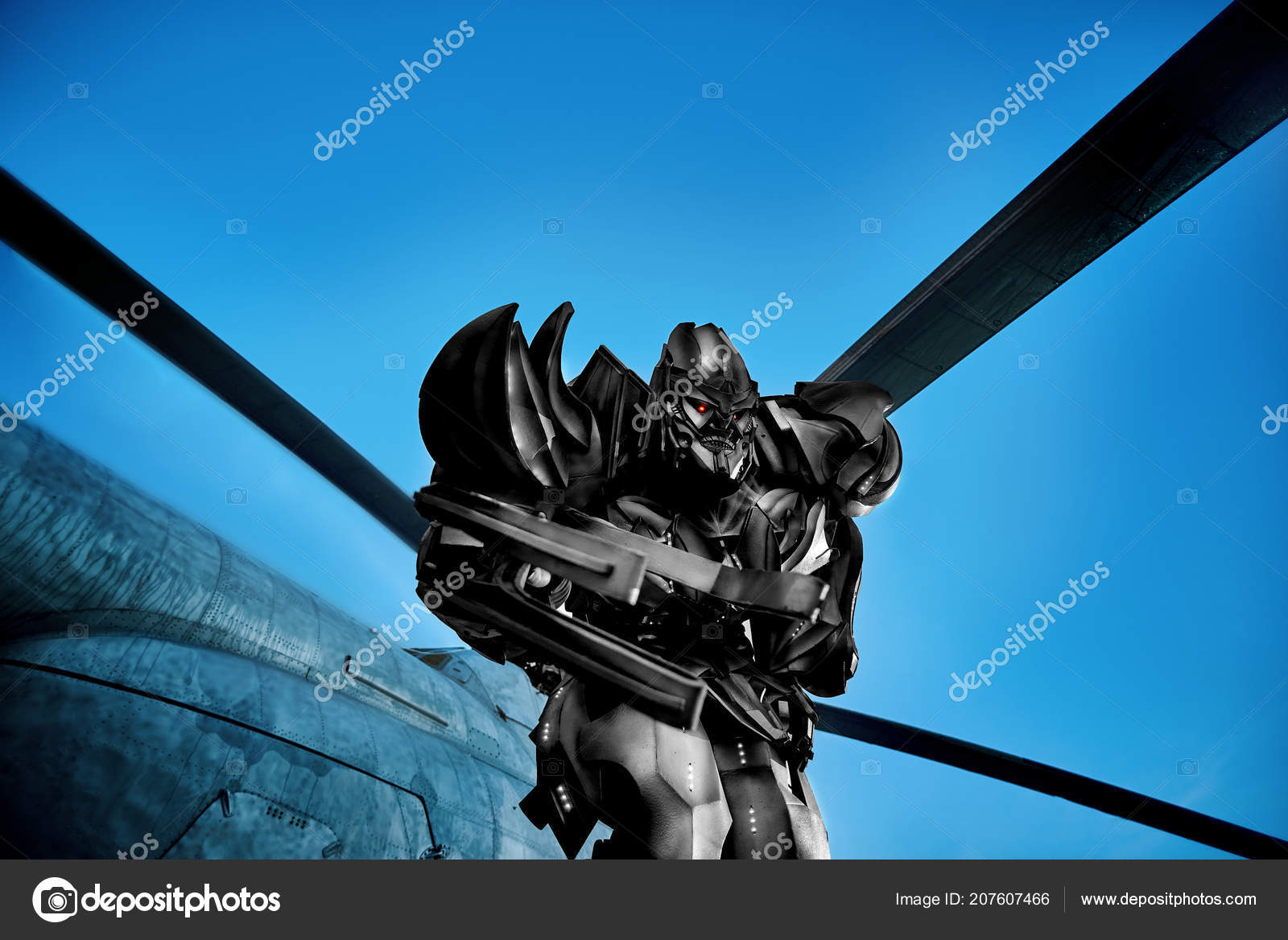 Side view of metallic transformer going near big helicopter in early ...