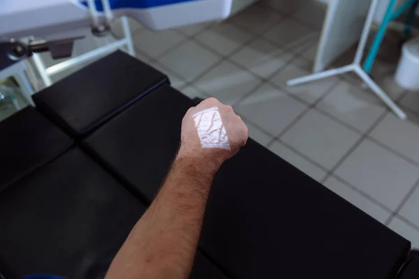 Close-up a doctors hand in a sterile office demonstrates the operation ...